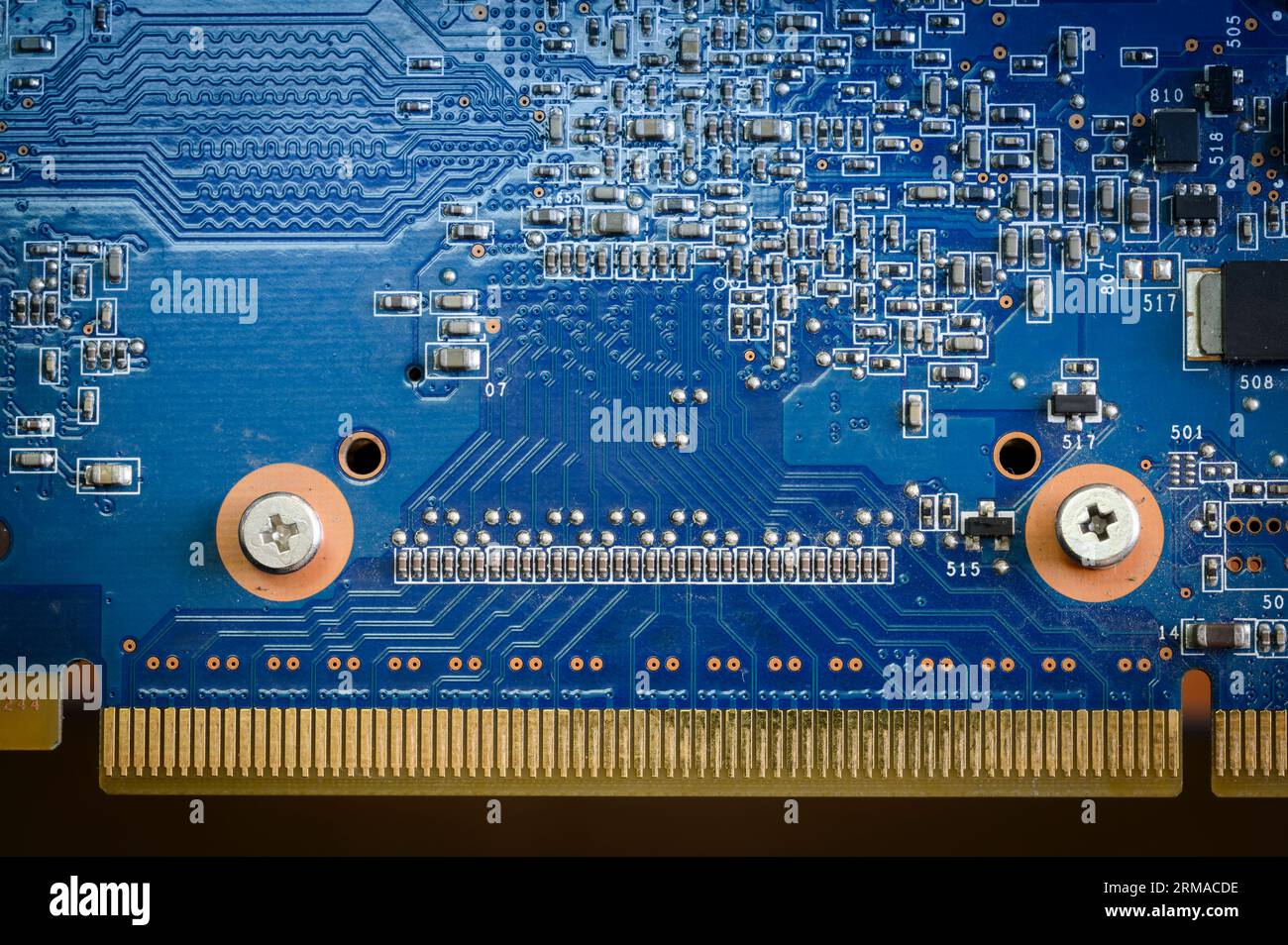 Blue computer board with screws, capacitors, microchip and gold-plated ...