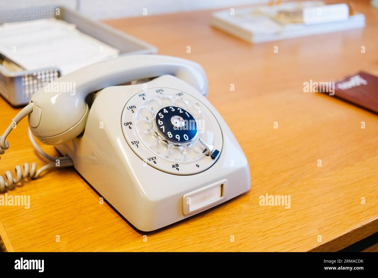 Old wheel and cord telephone, white, vintage Stock Photo - Alamy