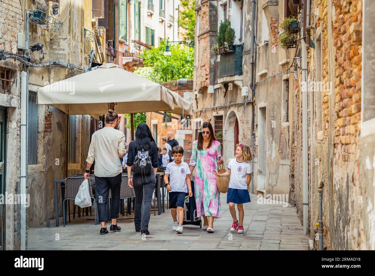 Venice, Italy - May 30 2023: Local scene from the cooblestone streets ...