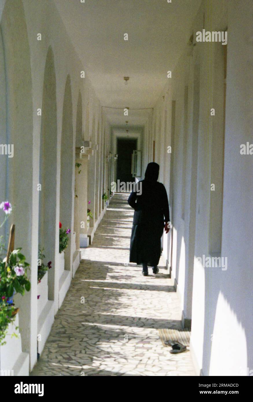 Galati County, Romania, 1999. Nun walking in the hallway in front of ...
