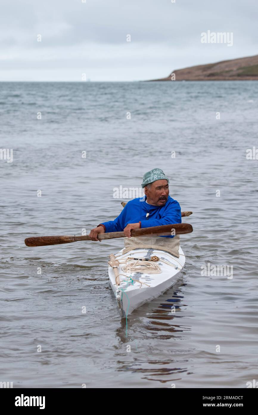 Northwestern Greenland. Man in traditional kayak Stock Photo - Alamy