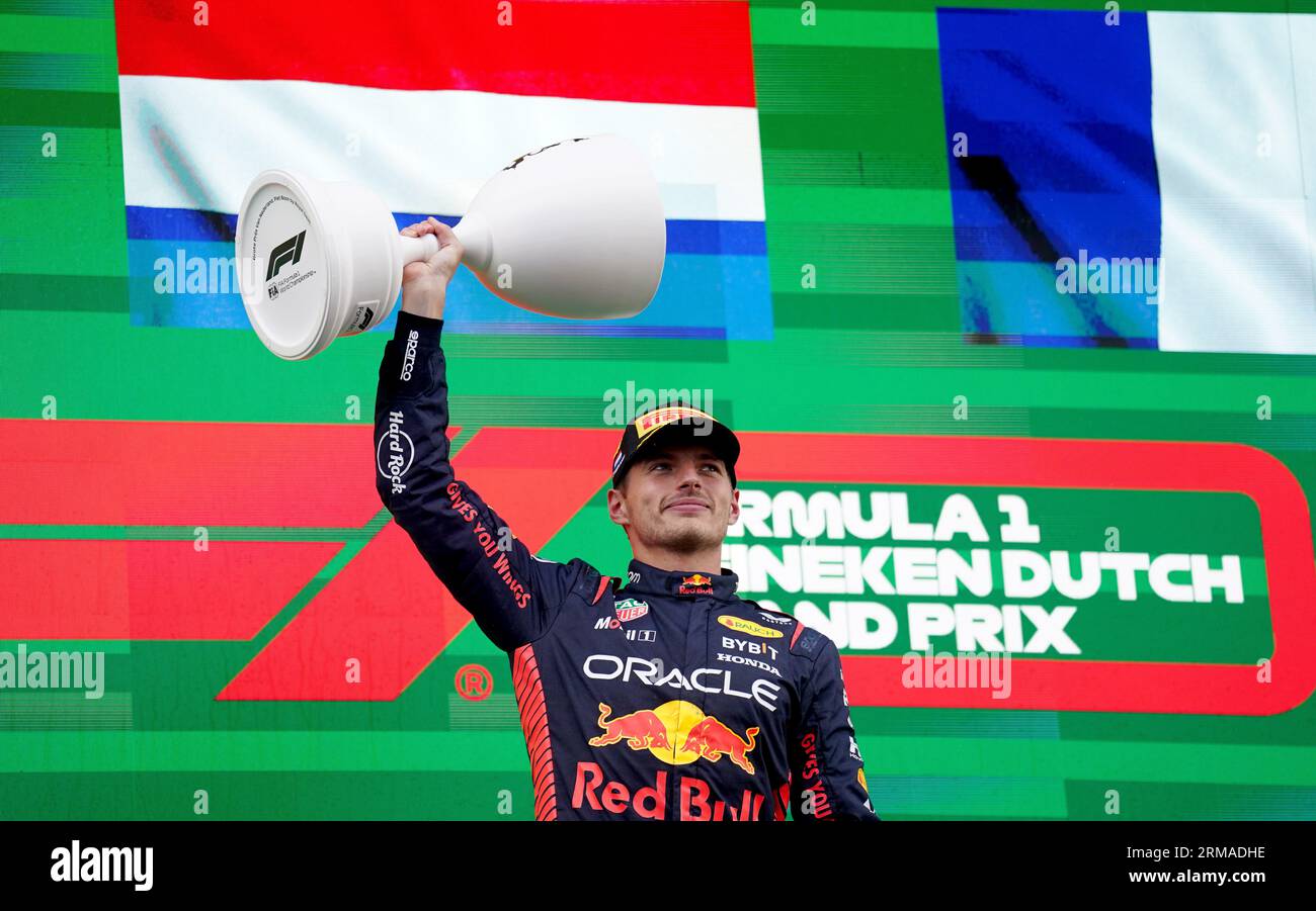 Red Bull Racing's Max Verstappen celebrates with the trophy on the ...