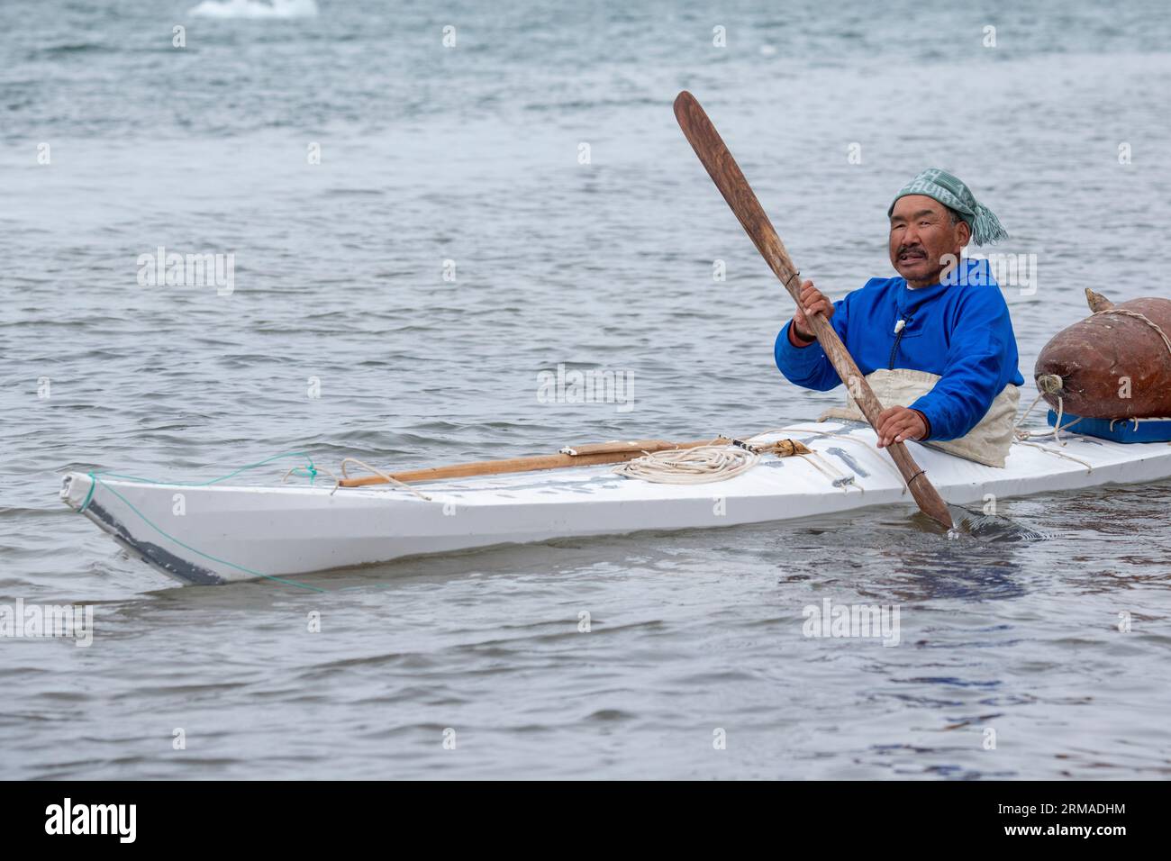 Northwestern Greenland. Man in traditional kayak Stock Photo - Alamy