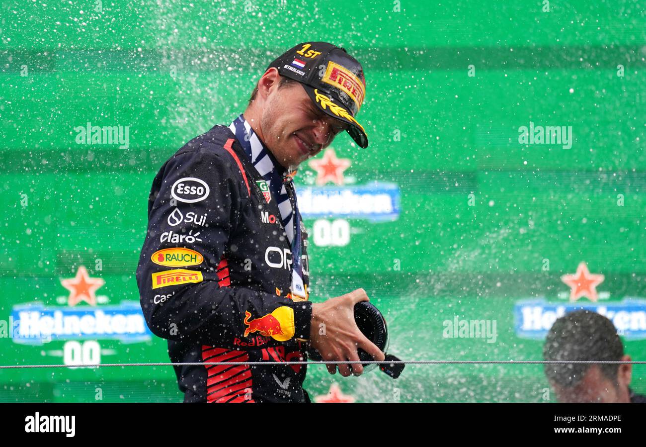 Red Bull Racing's Max Verstappen sprays champagne on the podium after ...