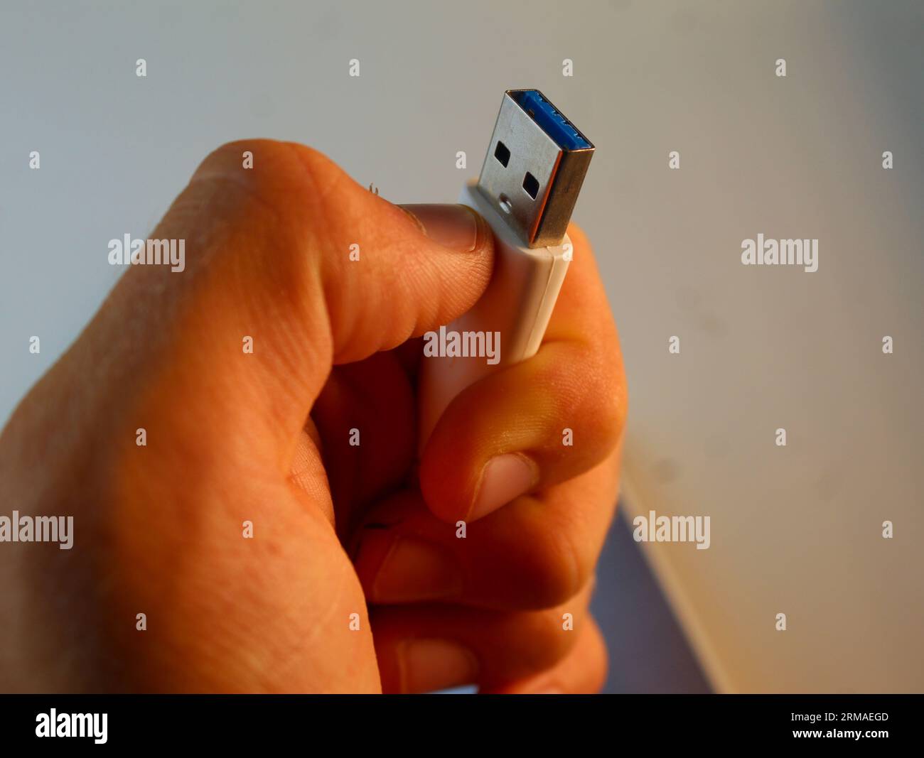 A photo of a white boy's hand holding a USB Stock Photo - Alamy