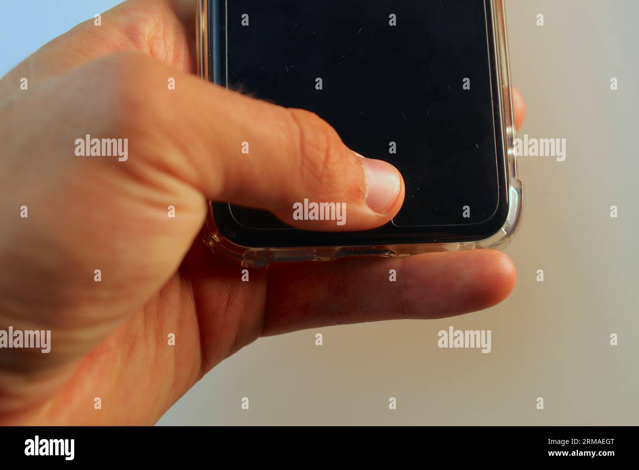 A photo of a person using their mobile phone Stock Photo - Alamy