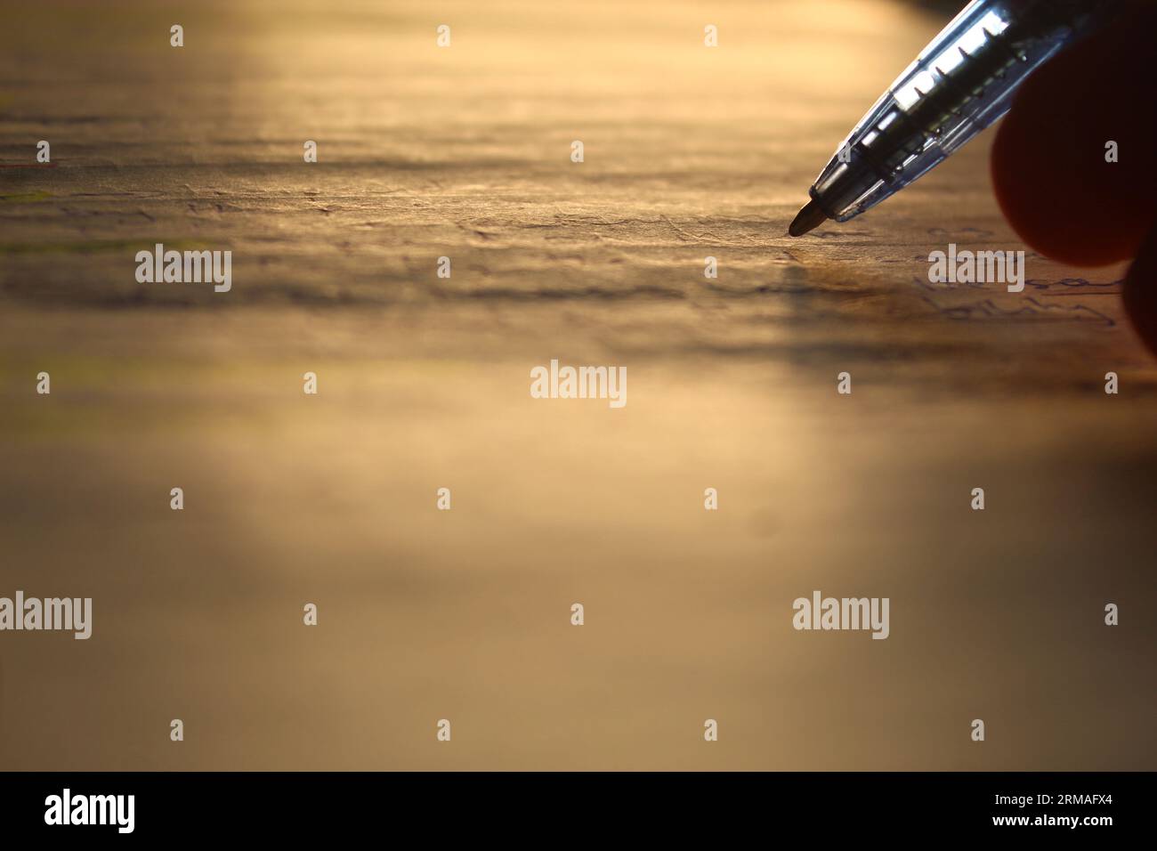 A close up photo of someone writing with a pen on a page full of notes ...
