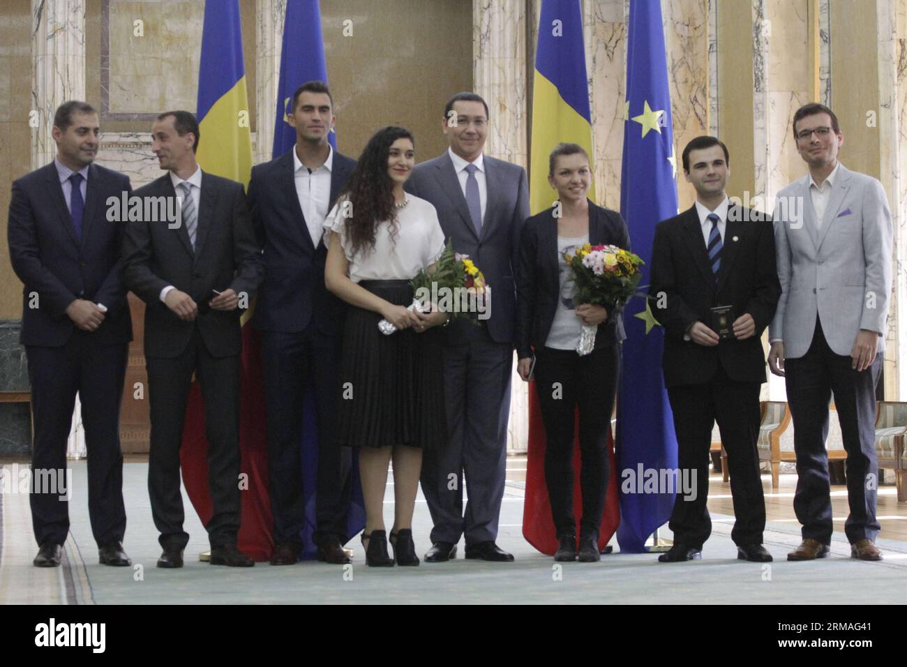 Romanian Prime Minister Victor Ponta (C) poses for a photo with six new ...