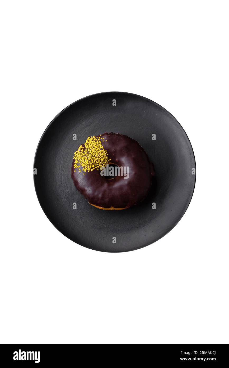 Delicious donut with cream filling and nuts on a dark concrete ...