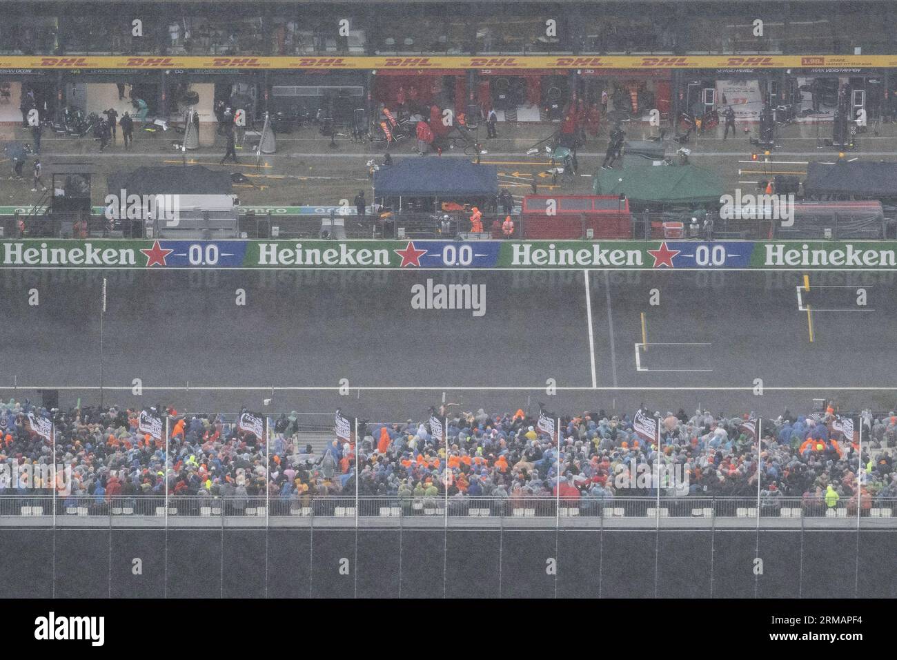 ZANDVOORT - Aerial view of F1 cars parked in the pit lane in the rain ...