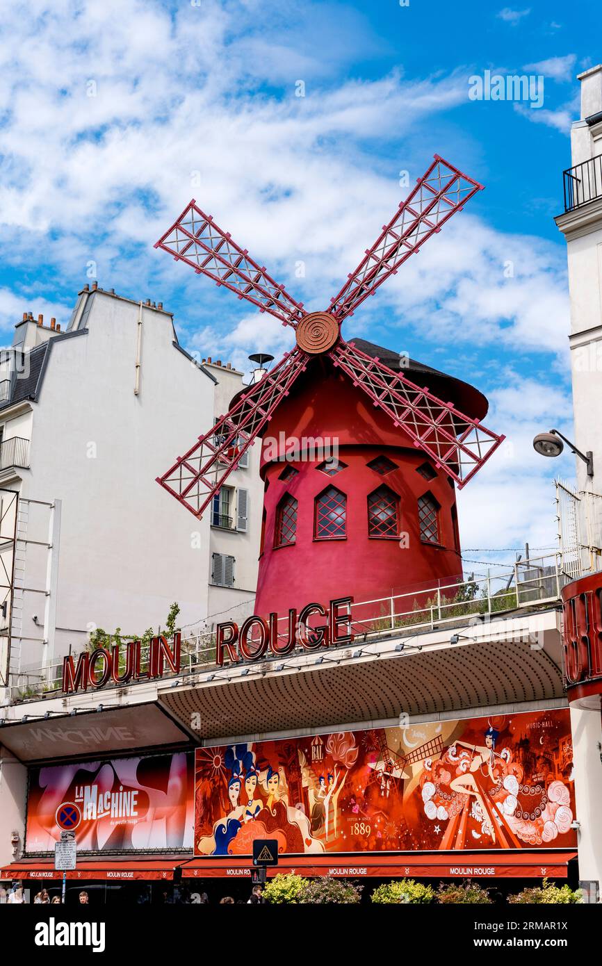 The Moulin Rouge, a vintage cabaret with the iconic red mill on top, in Place Blanche ...