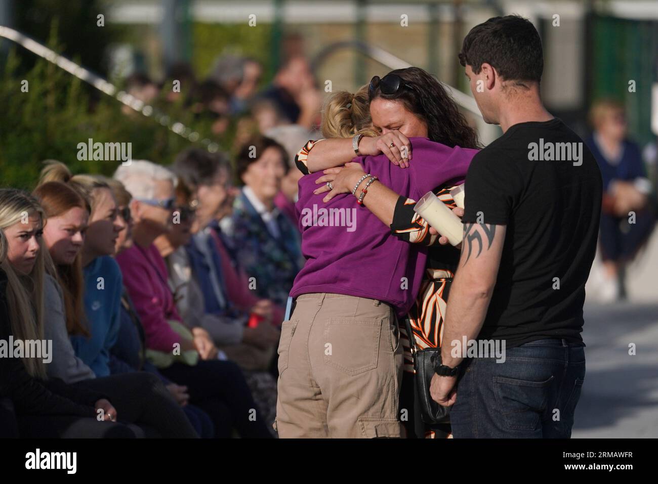 People comfort each other ahead of a vigil in Kickham Plaza, Co ...