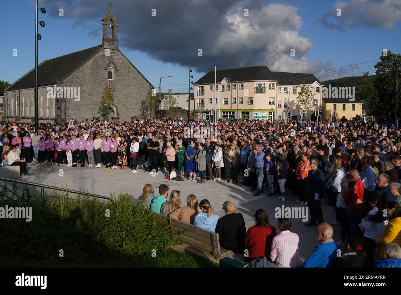 People attend a vigil in Kickham Plaza, Co Tipperary, in memory of Luke ...