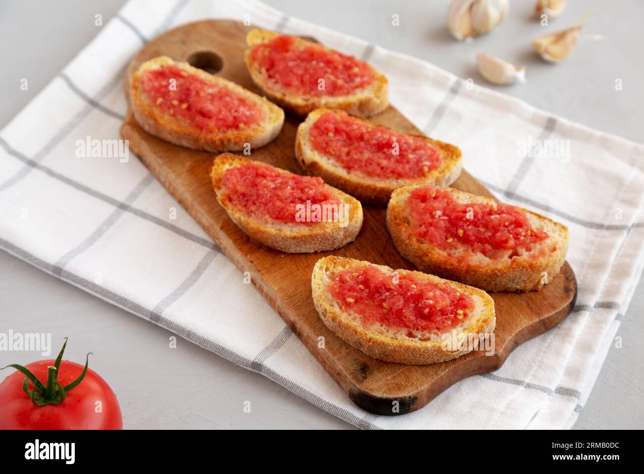 Homemade Pan Con Tomate (Tomato Toast) on a Rustic Wooden Board, side ...