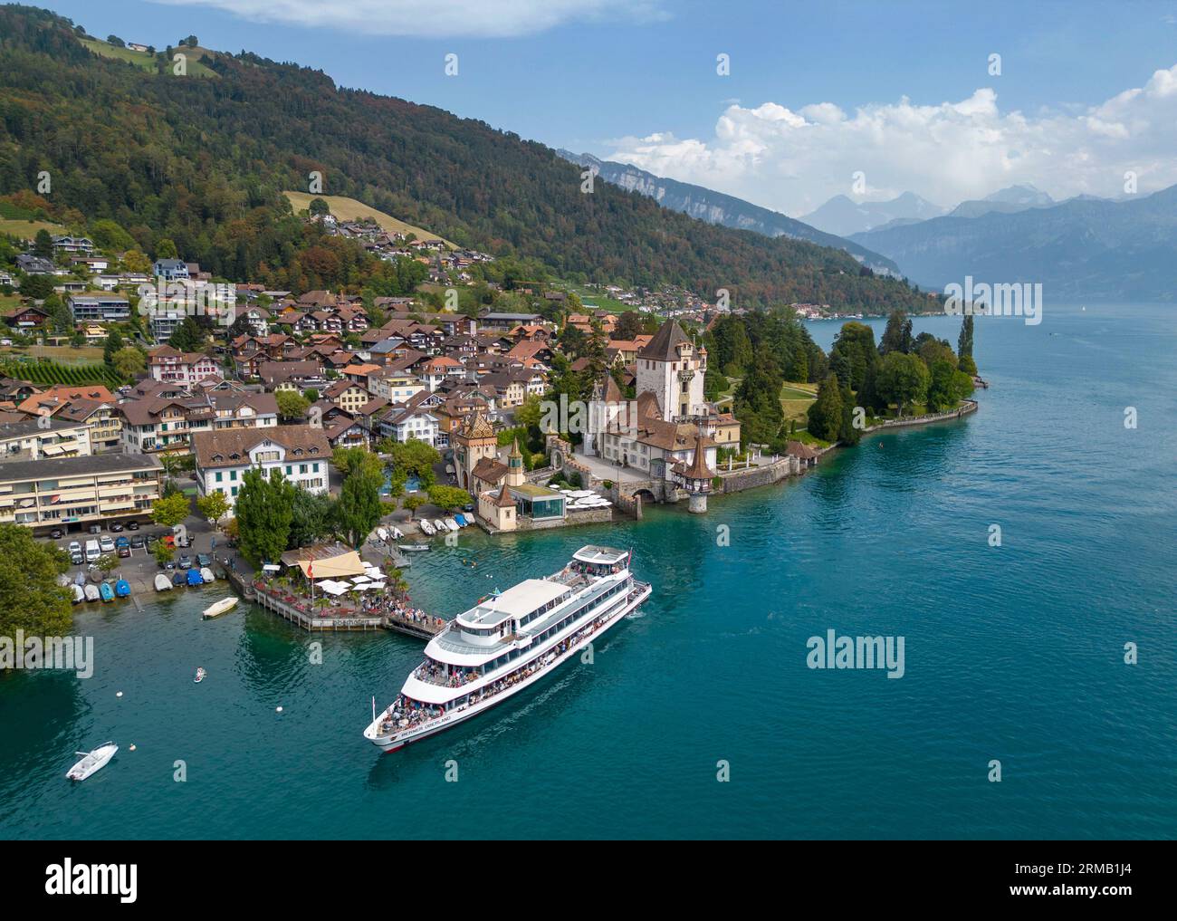Aerial view of Berner Oberland cruise ship docking at Oberhofen Castle ...