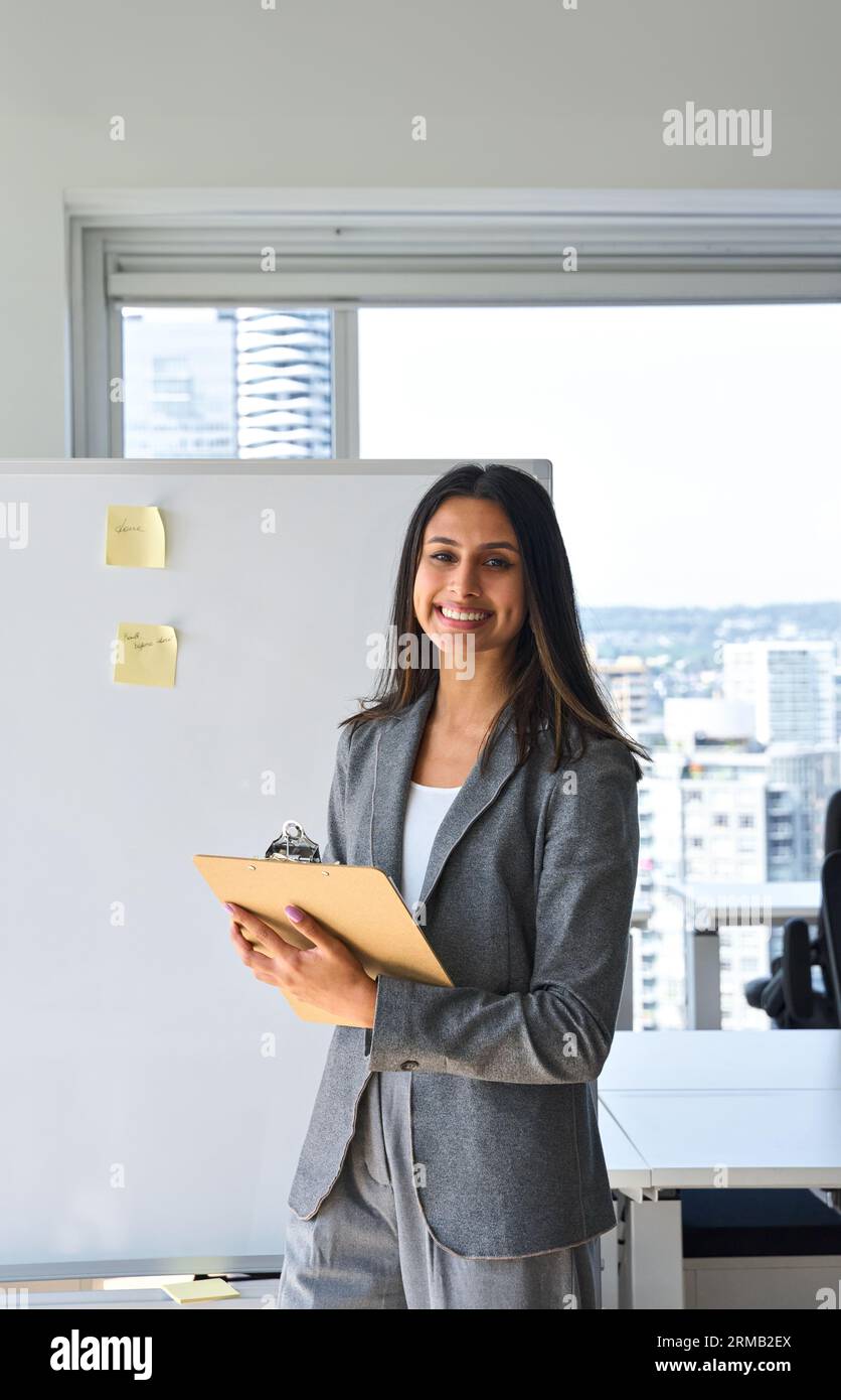 Happy professional Indian business woman standing in office, portrait ...