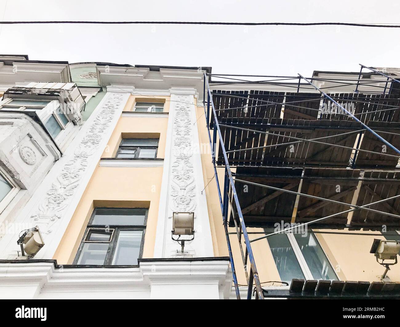 Repair work on the facade of the building with the help of wooden ...