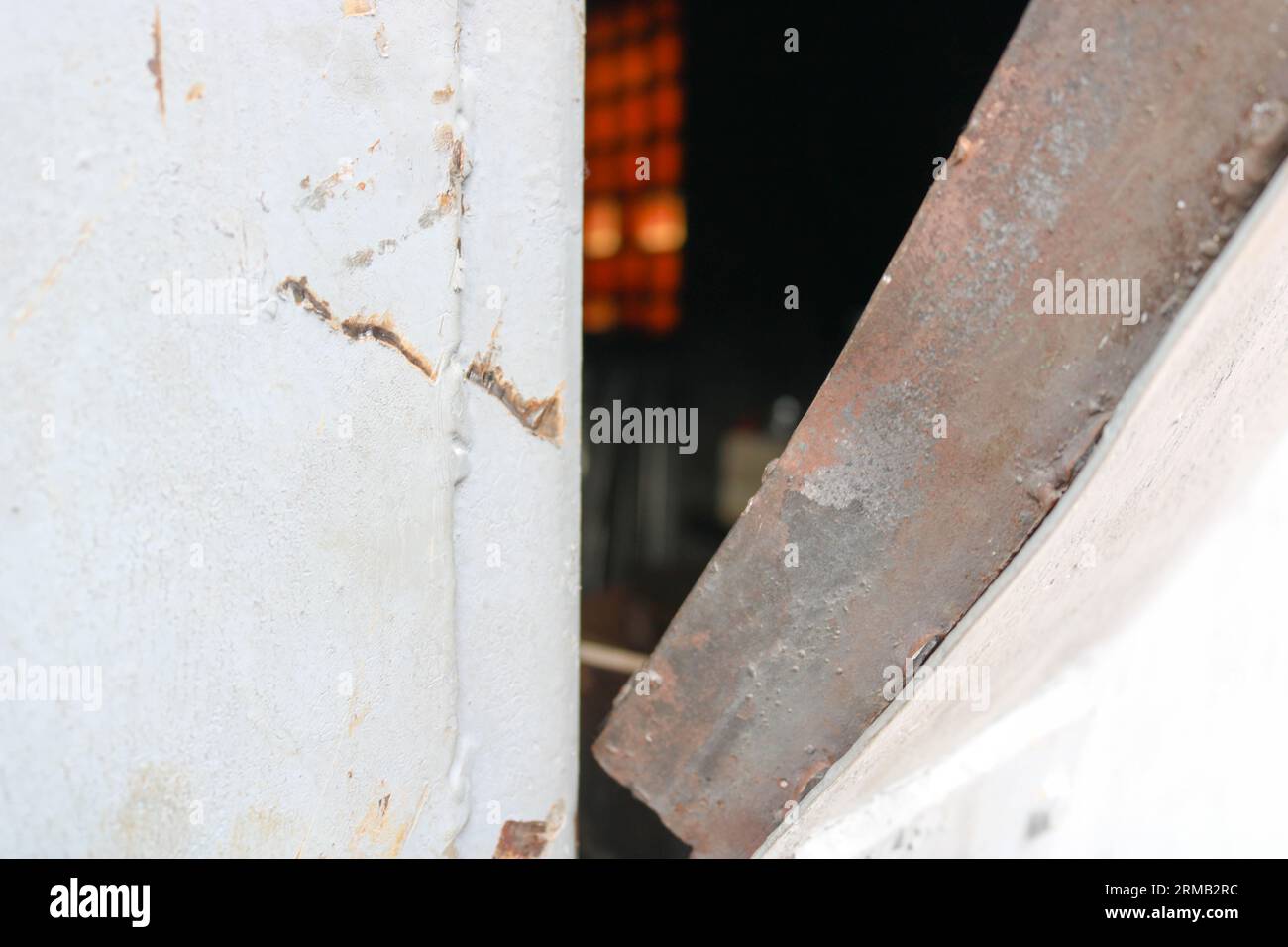 The texture of the blue broken out bent hacked iron metal door with a ...