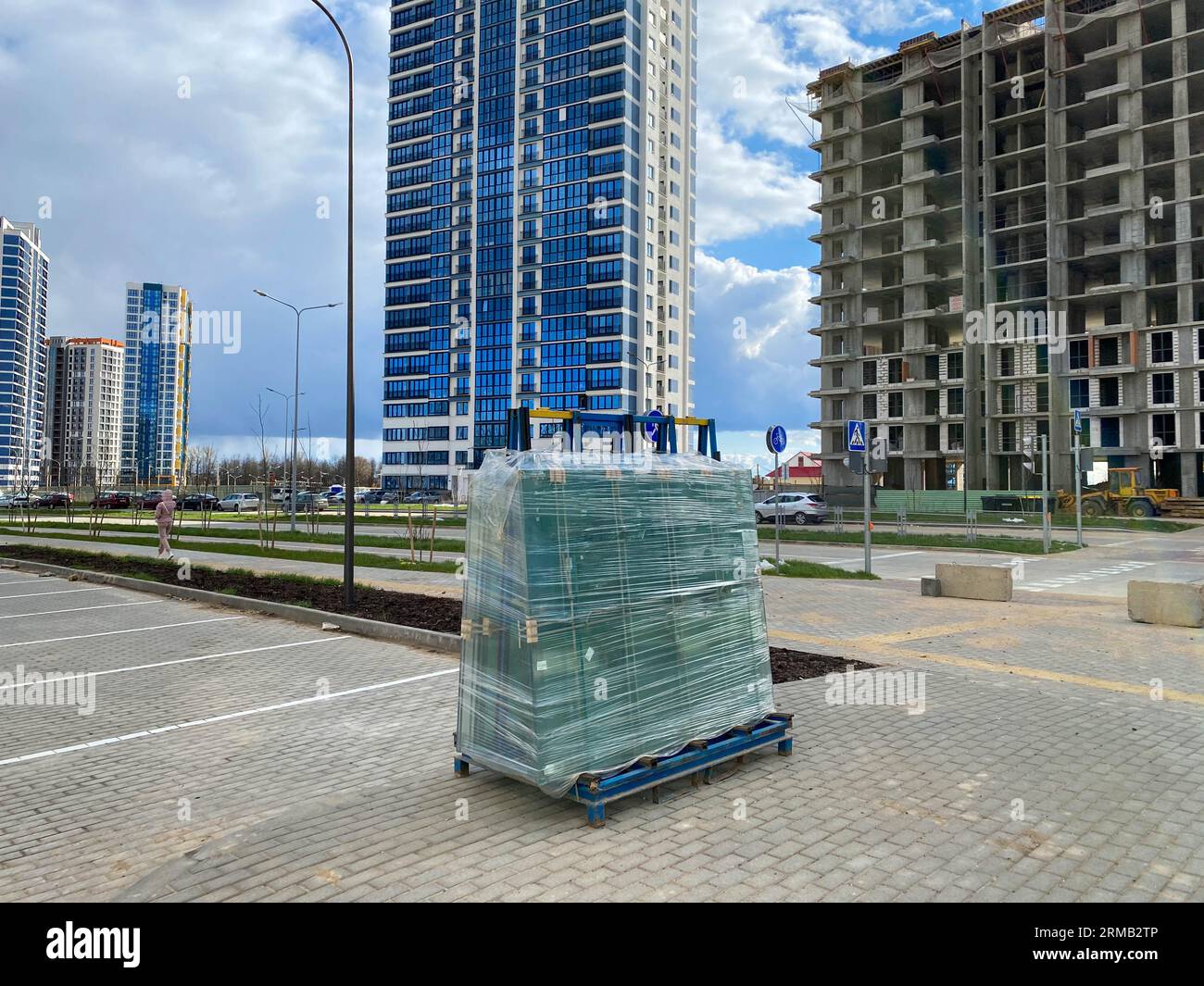 A large package of glass for windows of double-glazed windows wrapped ...