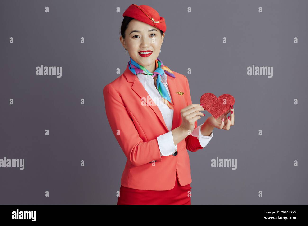 happy stylish air hostess asian woman in red skirt, jacket and hat ...