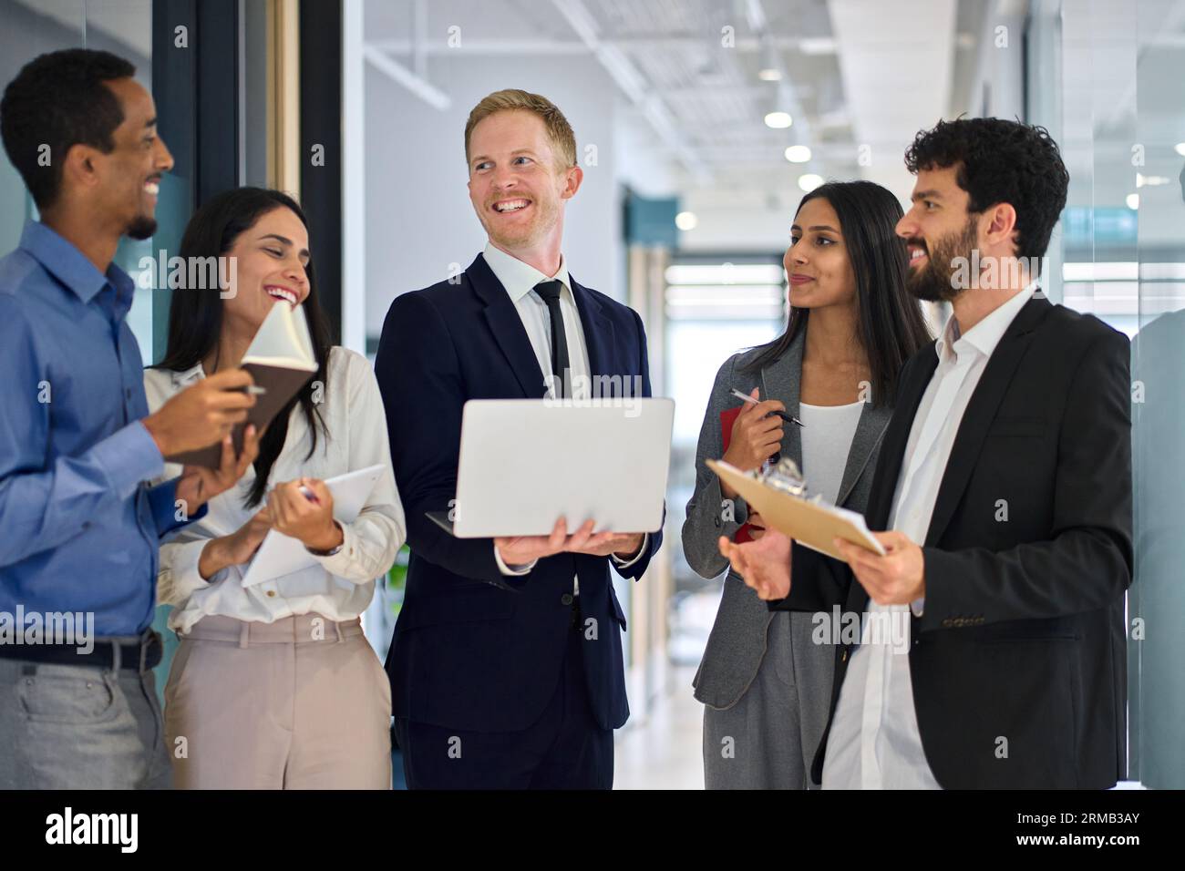 Happy international professional team business people talking in office ...