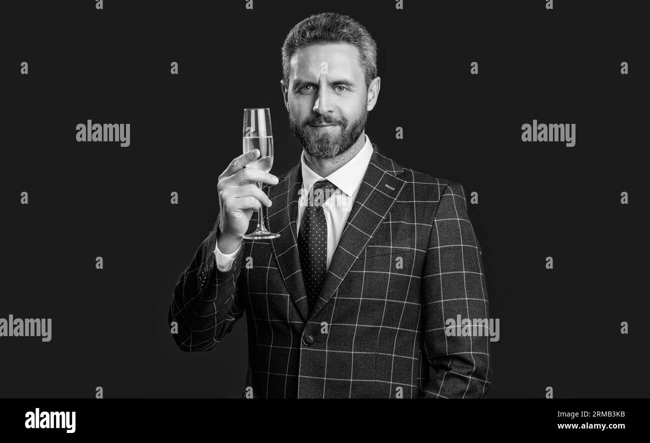 cheerful man cheering with champagne to celebrate. man in studio ...