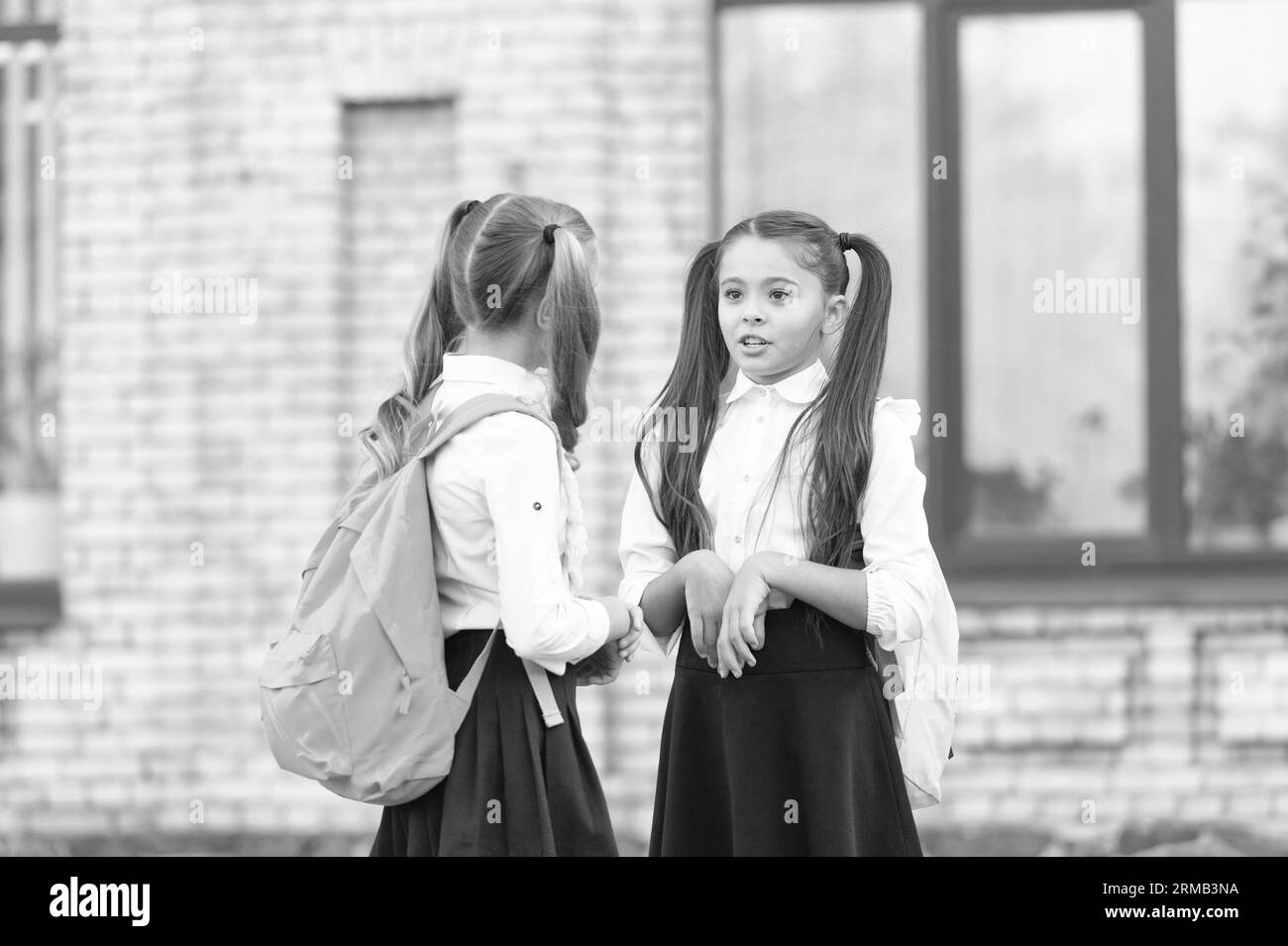 two school girls friends talk together outdoor Stock Photo - Alamy