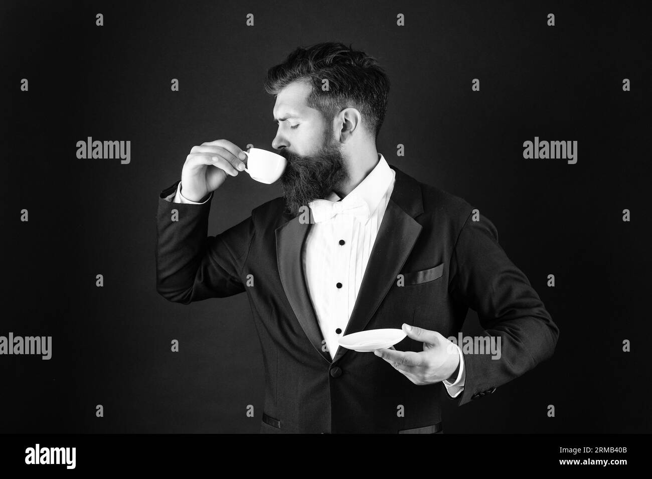 man in tuxedo bow tie with coffee cup. gentleman in formalwear drinking ...