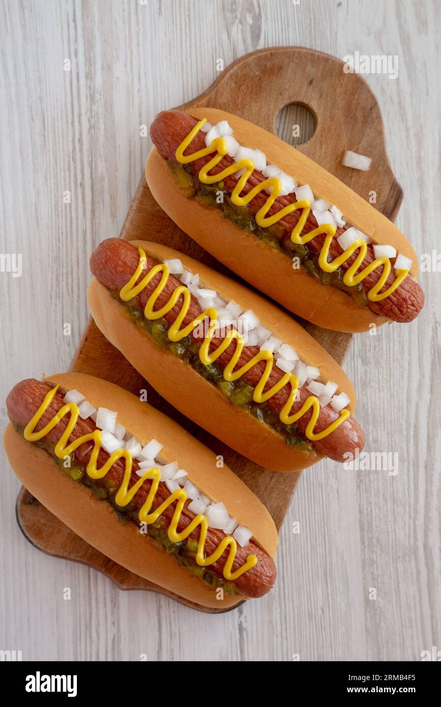 Char Grilled Hot Dog with Mustard, Relish and Onion on a rustic wooden ...