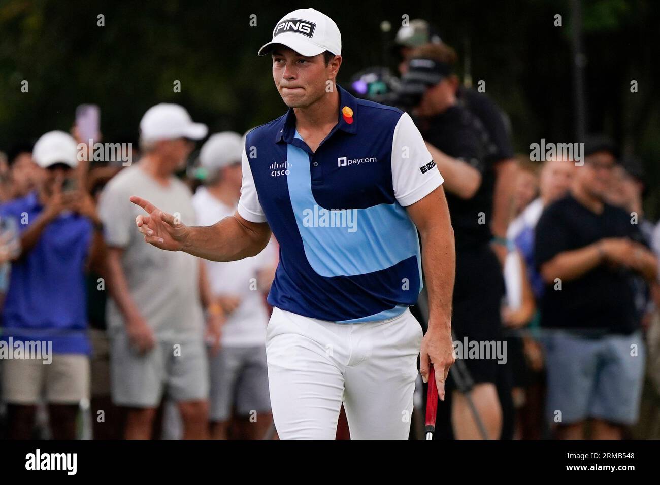 Viktor Hovland, of Norway, reacts to his putt on the first green during ...