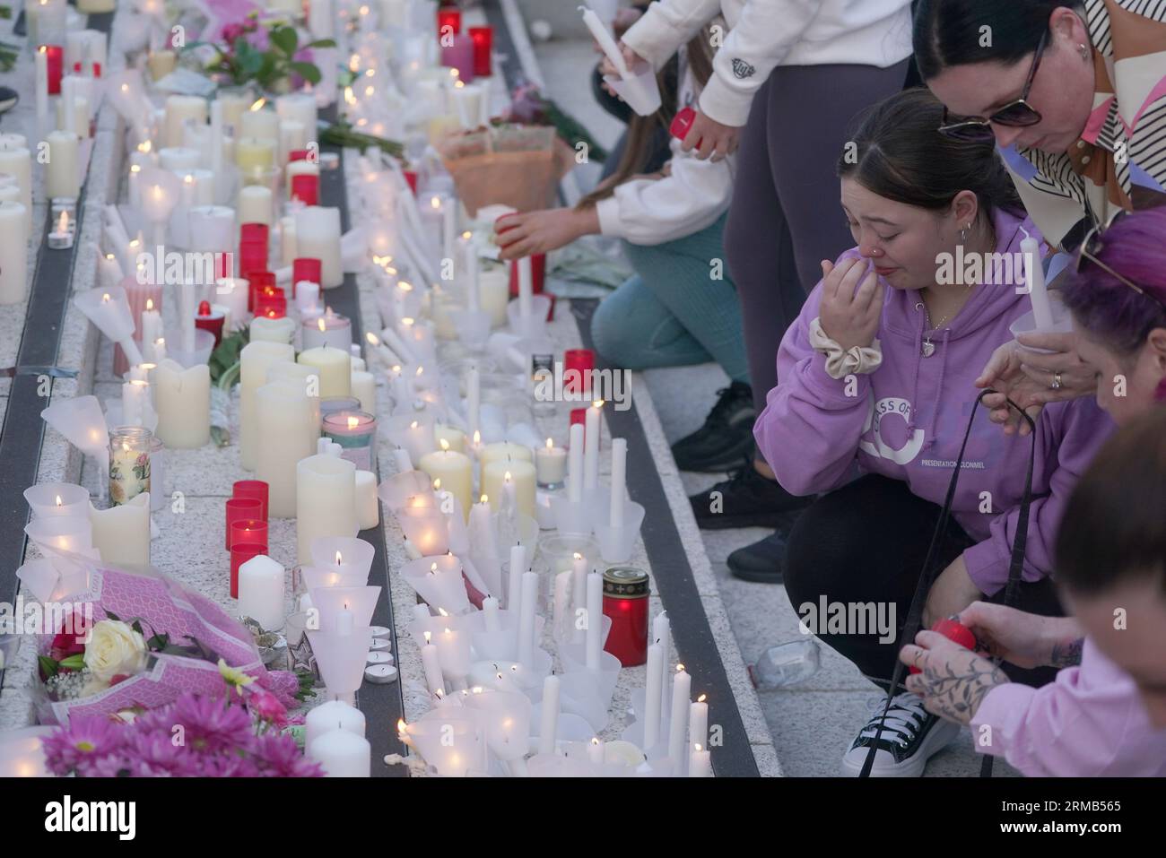 People light candles at the end of the vigil in Kickham Plaza, Co ...