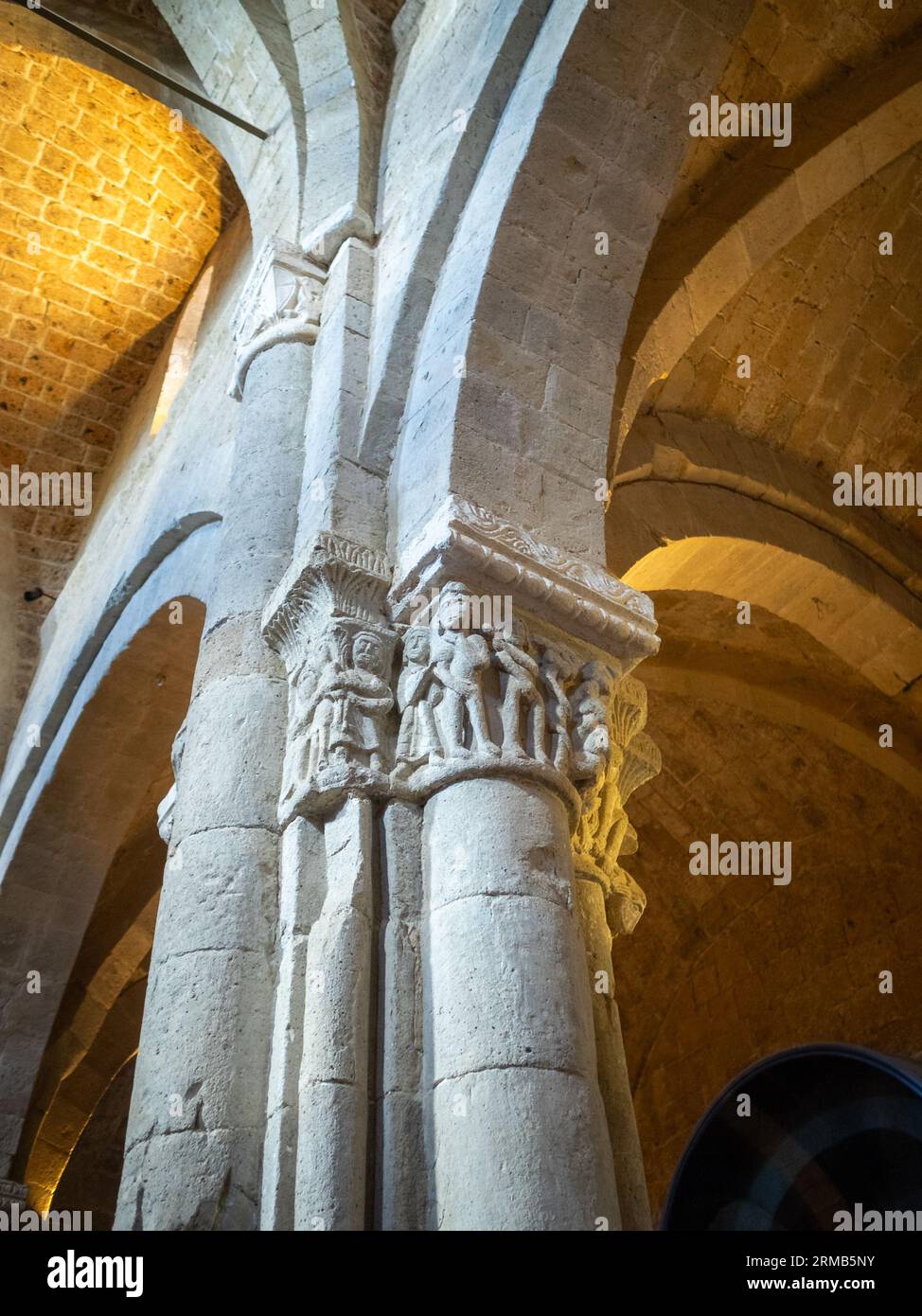 Adma and Eve represented in a column chapiter at Sovana Cathedral Stock ...