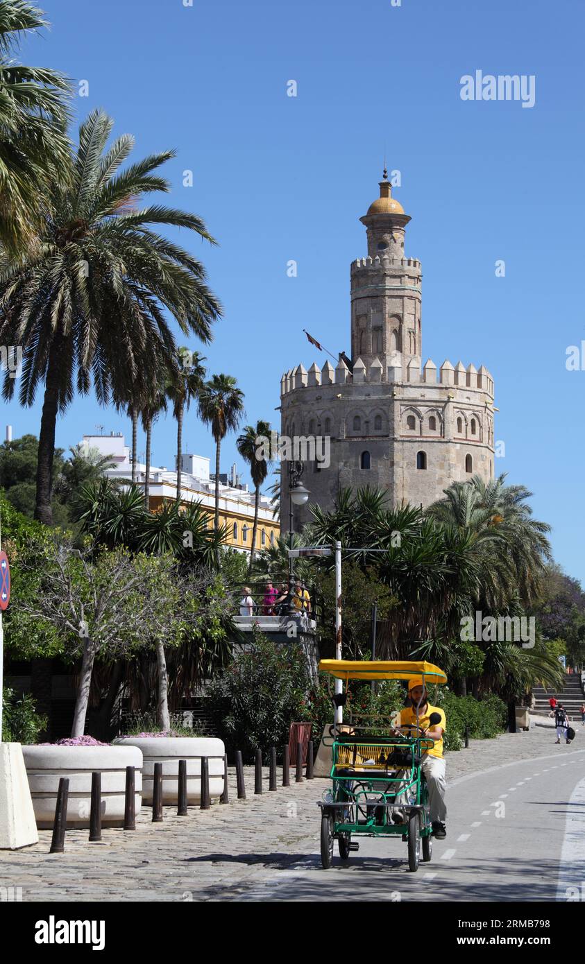 A man drives a four wheel tourist go cart near the Golden Tower, Torre ...