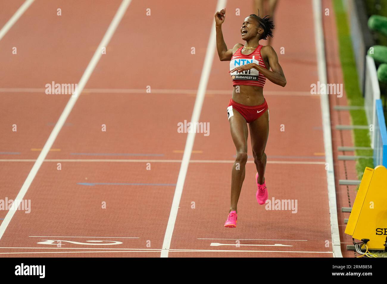 Winner Winfred Mutile Yavi, of Bahrain, crosses the finish line in the ...