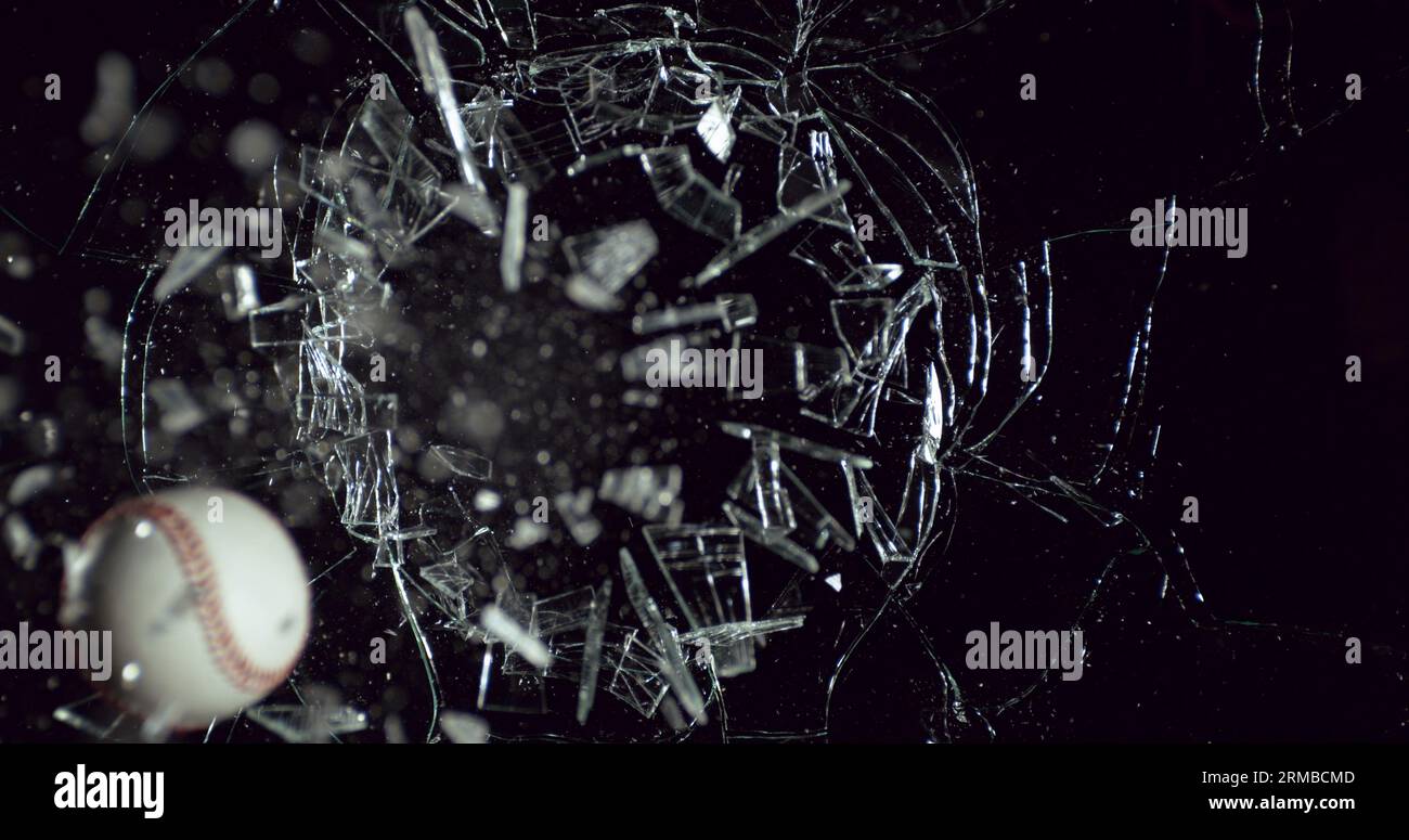 Ball of Baseball breaking Pane of Glass against Black Background Stock ...