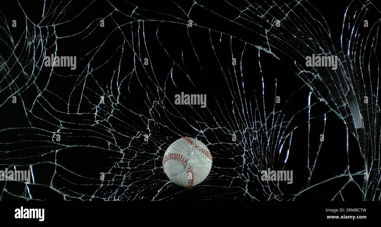 Ball of Baseball breaking Pane of Glass against Black Background Stock ...