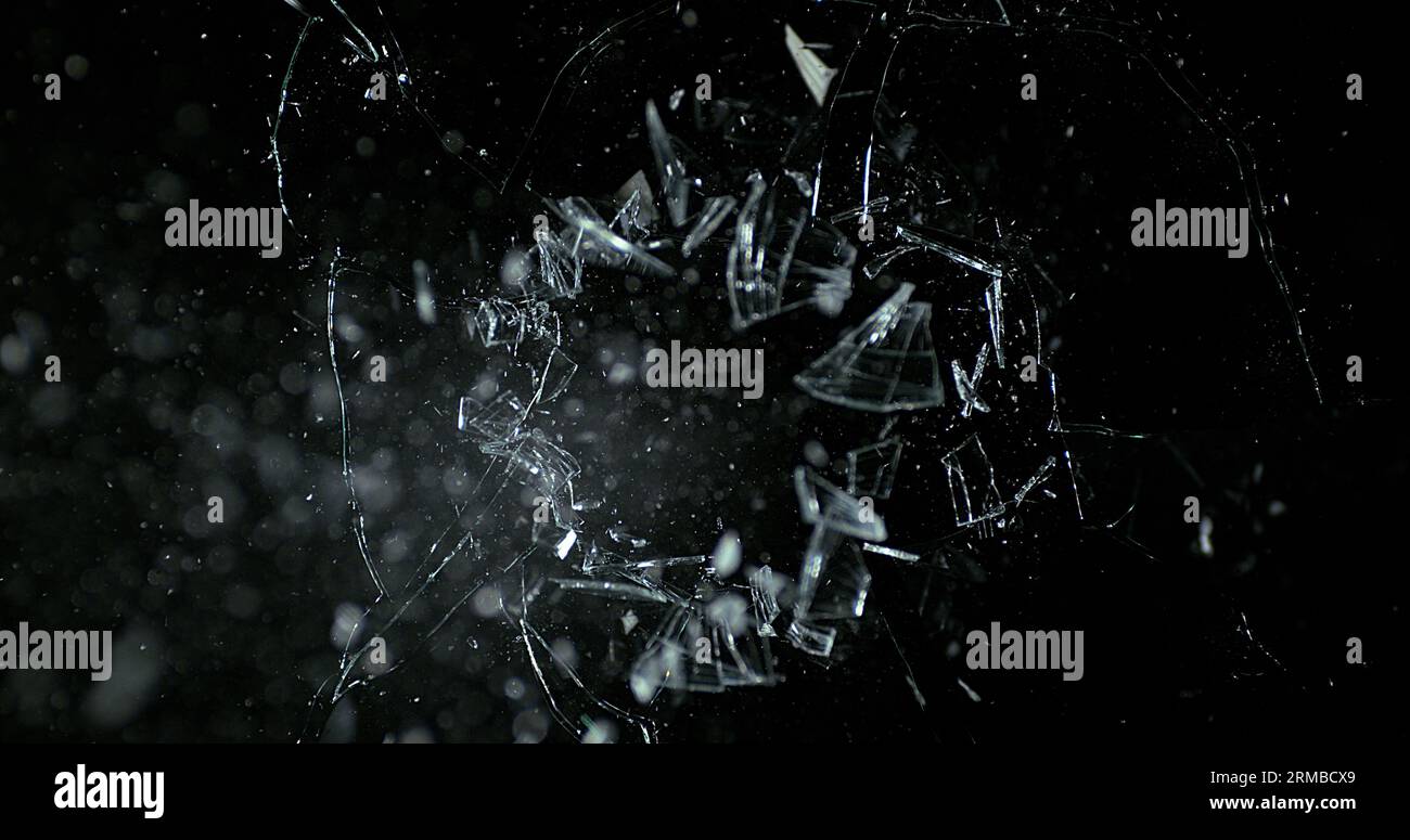 Golf Ball breaking Pane of Glass against Black Background Stock Photo ...