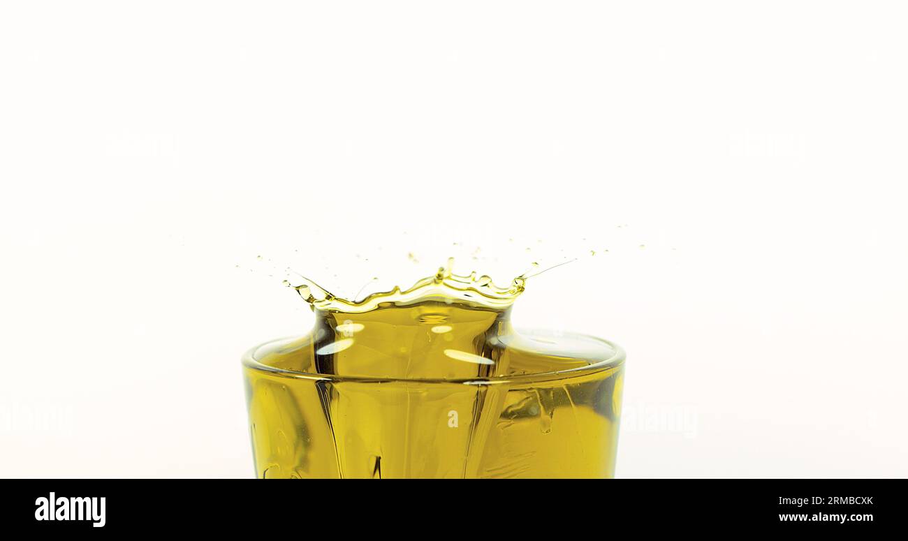 Olives Falling into Olive Oil against White Background Stock Photo - Alamy