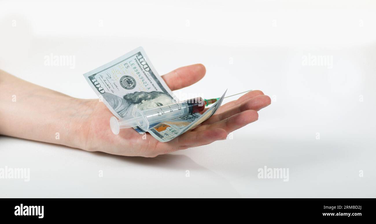 Syringe Falling into Hand with Dollars against White Background Stock ...