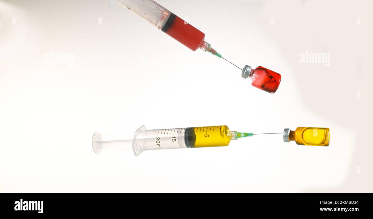 Syringe Falling against White Background Stock Photo - Alamy