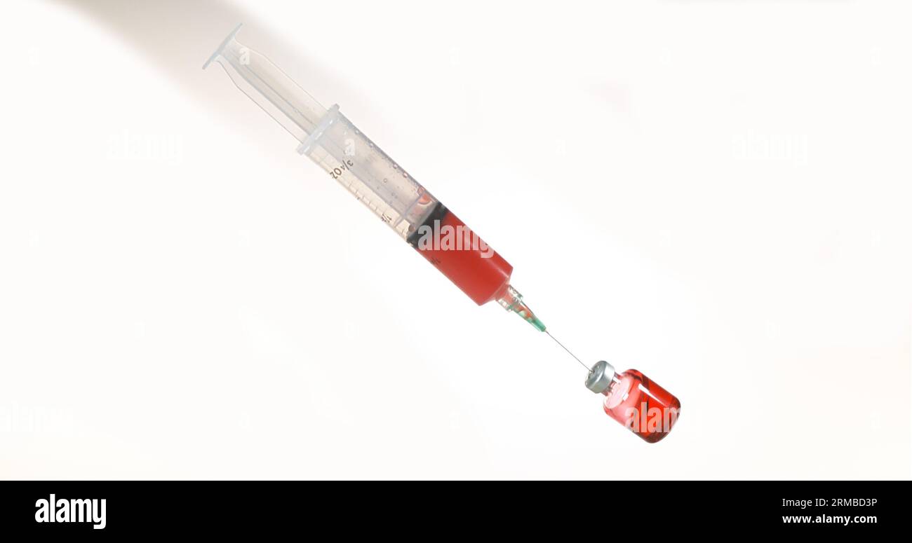 Syringe Falling against White Background Stock Photo - Alamy