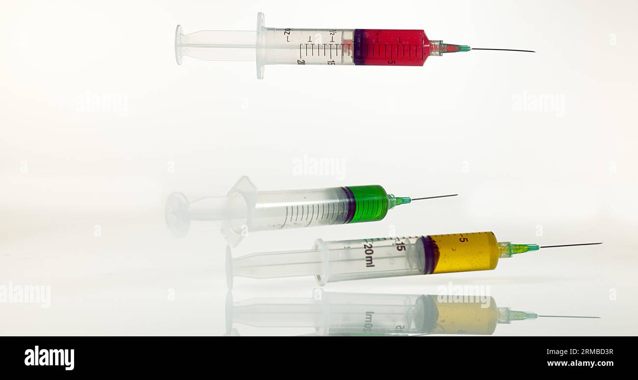 Syringe Falling against White Background Stock Photo - Alamy