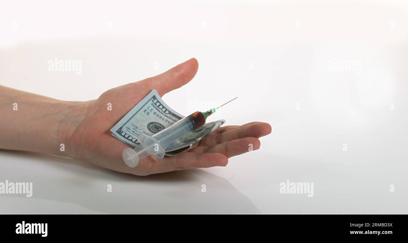 Syringe Falling into Hand with Dollars against White Background Stock ...