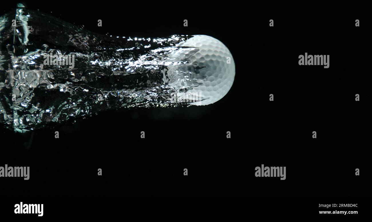 Golf's Ball Falling into Water against Black background Stock Photo - Alamy