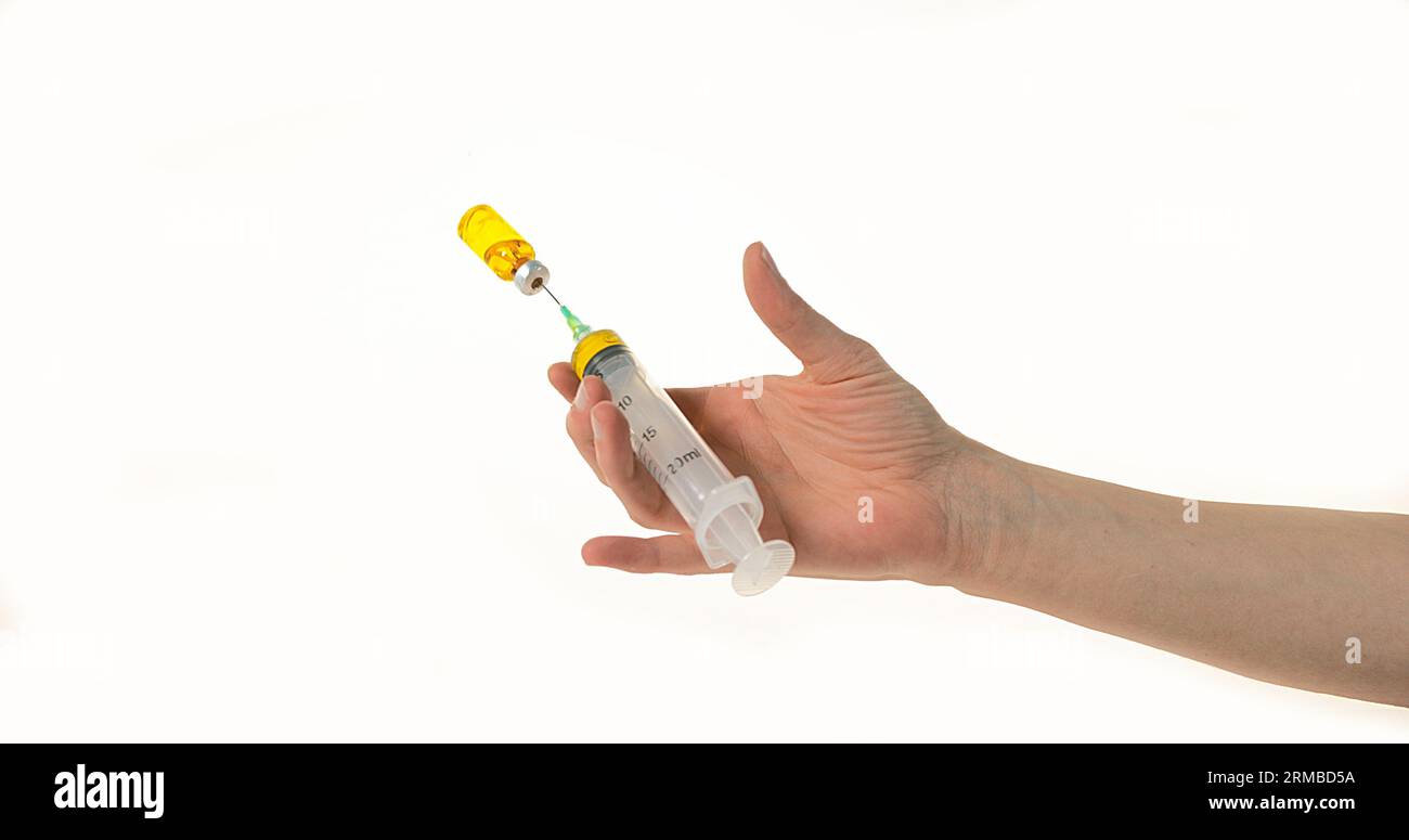 Syringe Falling into Hand against White Background Stock Photo - Alamy