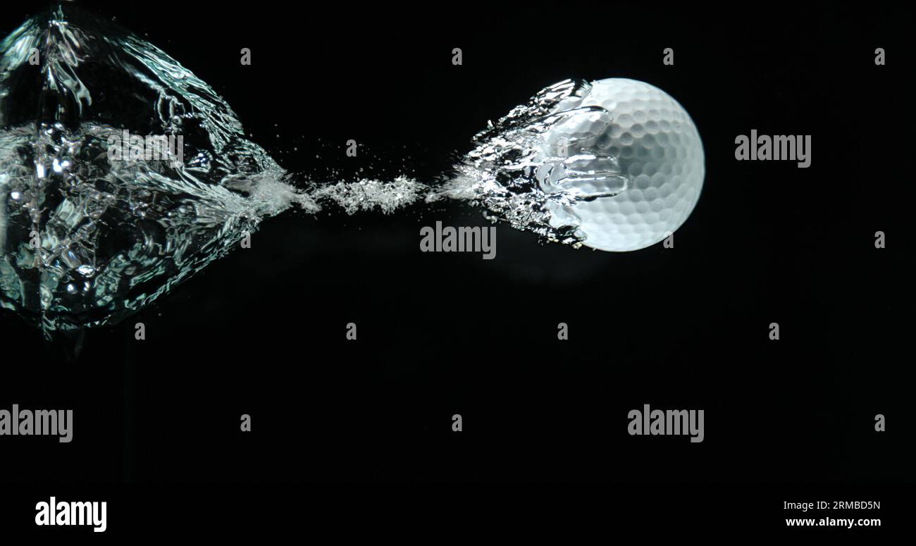 Golf's Ball Falling into Water against Black background Stock Photo - Alamy