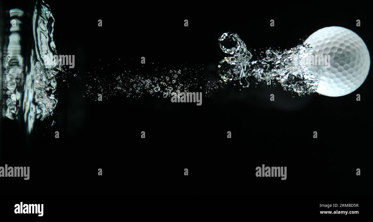 Golf's Ball Falling into Water against Black background Stock Photo - Alamy