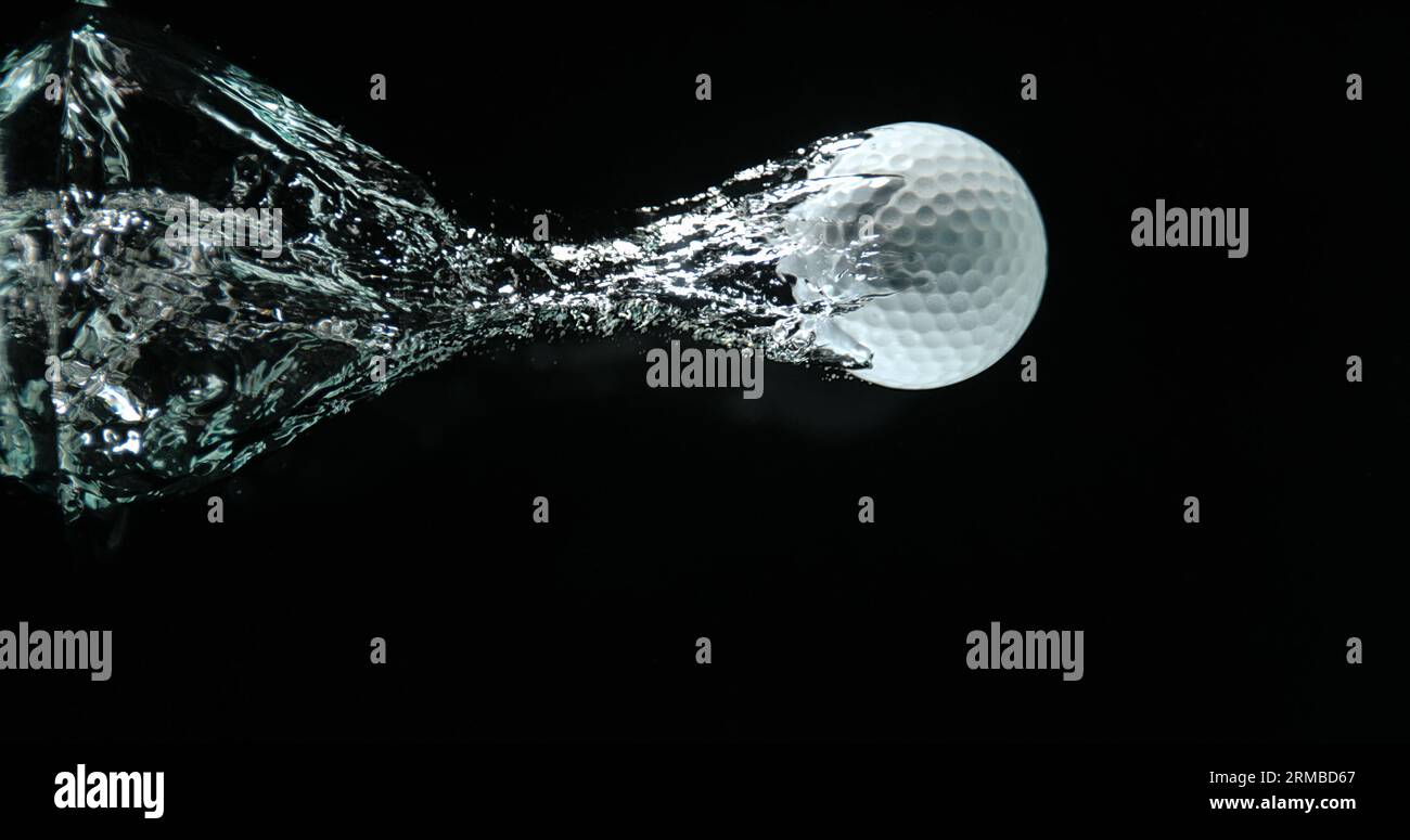 Golf's Ball Falling into Water against Black background Stock Photo - Alamy