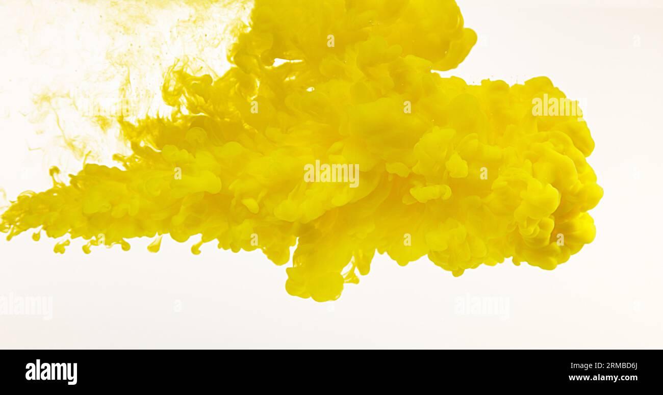 Yellow Ink entering Water against white Background Stock Photo - Alamy