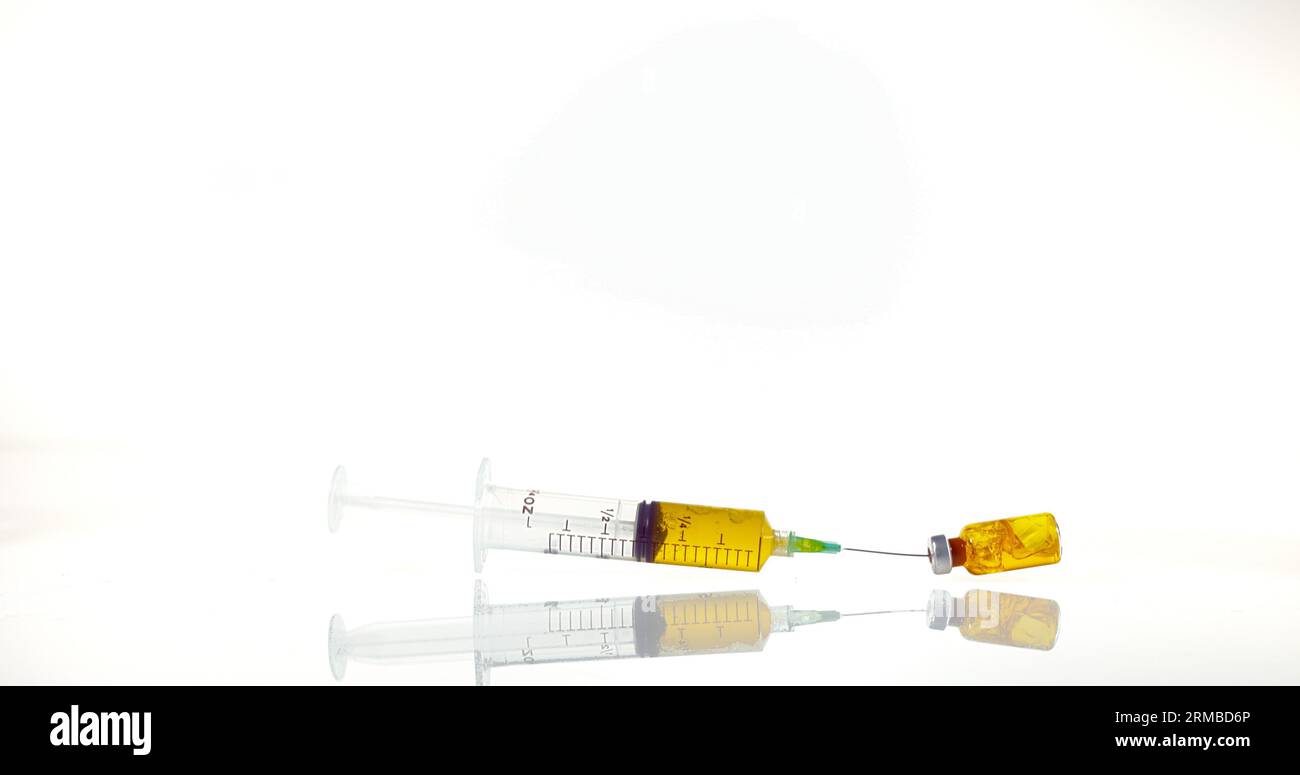 Syringe Falling against White Background Stock Photo - Alamy